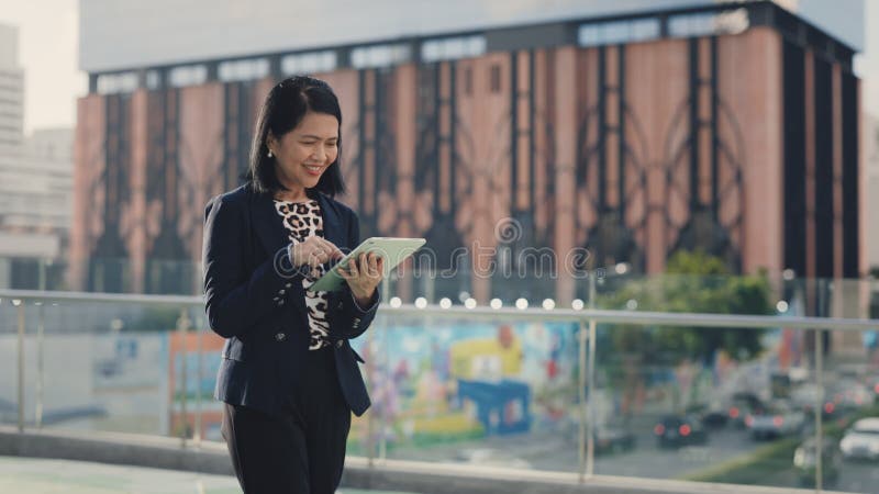 Woman Walking in the City and Using Digital Tablet, Using Online ...