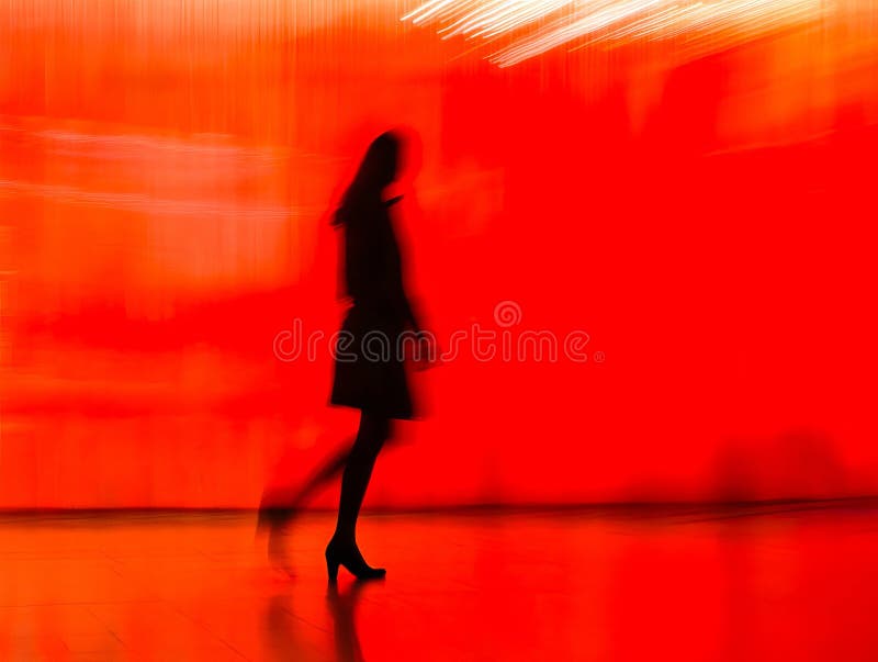 A Woman Walking in Front of a Red Wall Stock Image - Image of shadow ...