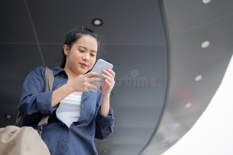 Woman is Walking Outdoors, Using Mobile Phone Stock Photo - Image of ...