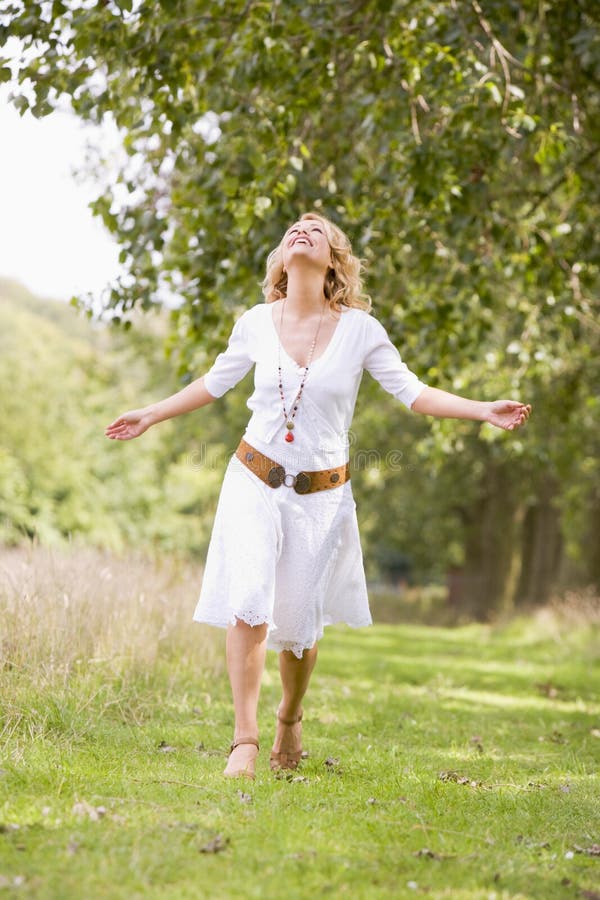 Woman Walking on Path Smiling Stock Photo - Image of vitality, length ...