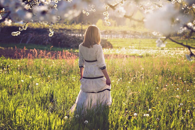 Woman Walking in a Spring Meadow Stock Photo - Image of graceful ...