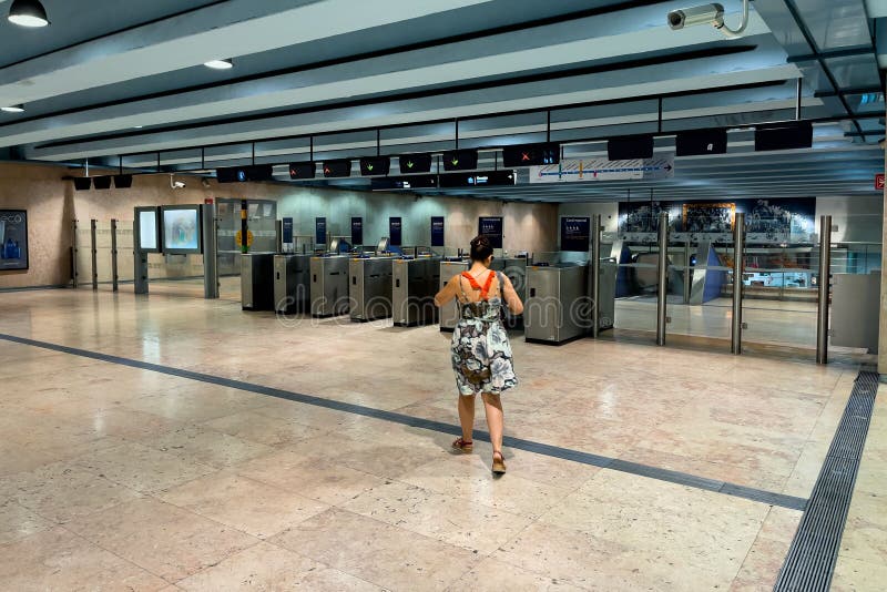 A Woman Walking Towards the Automatic Gates Inside a Metro Station ...