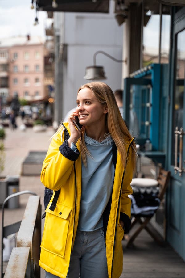 Woman Walking and Using a Smartphone in the Street Stock Photo - Image ...