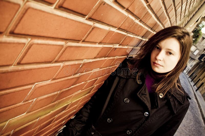 Woman on wall stock image. Image of dark, brickwall, attractive - 5300113