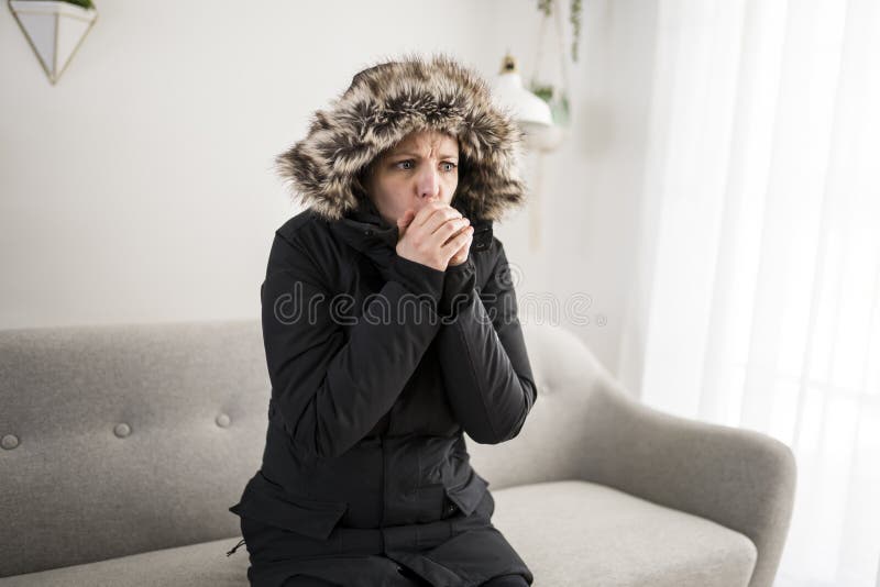 Woman with Warm Clothing Feeling the Cold Inside House on the Sofa ...