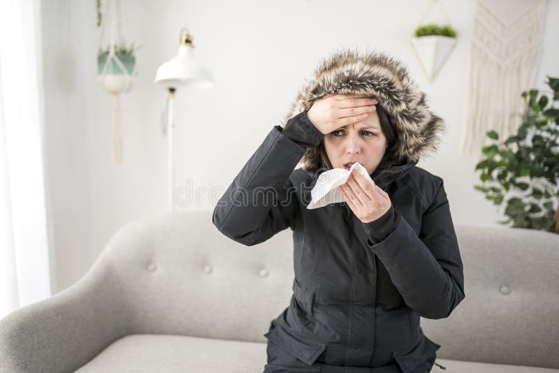 Woman with Warm Clothing Feeling the Cold Inside House on the Sofa she ...