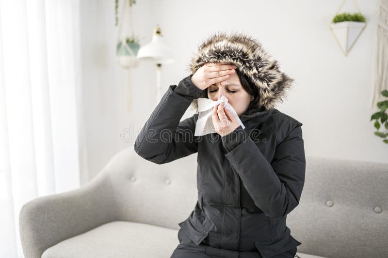 Woman with Warm Clothing Feeling the Cold Inside House on the Sofa she ...