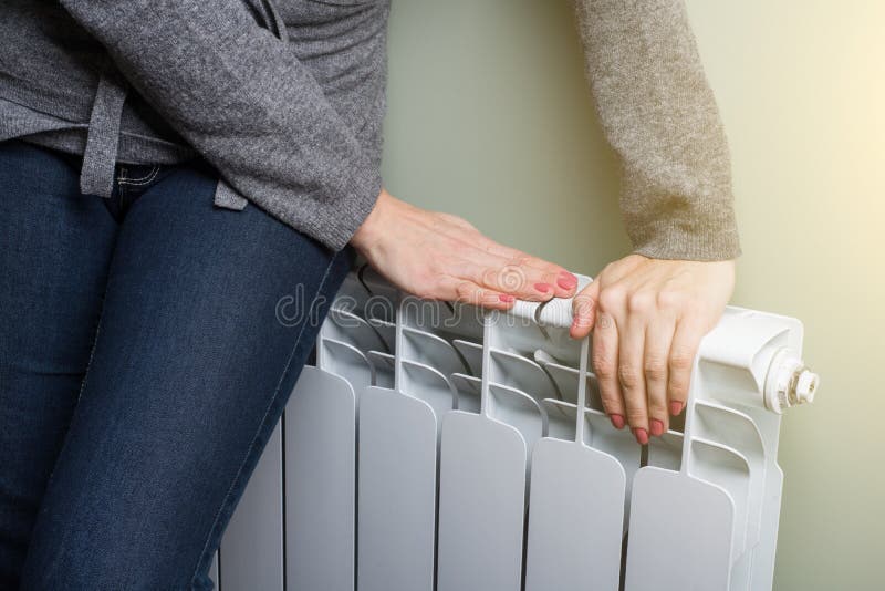 Woman Warming Her Hands on the Radiator Panel Stock Photo - Image of ...