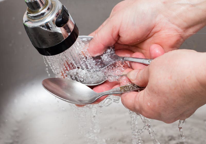 Woman Washes Spoons Under a Tap of Water Stock Photo - Image of ...