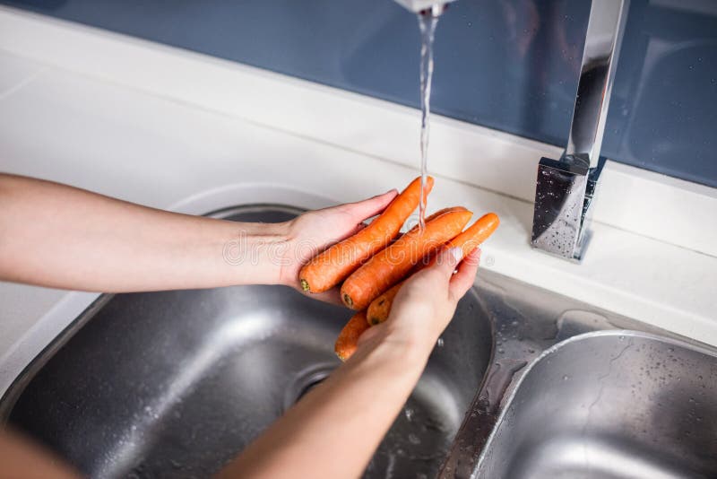 Woman Washing Carrots at Kitchen Sink Stock Image - Image of hygiene ...