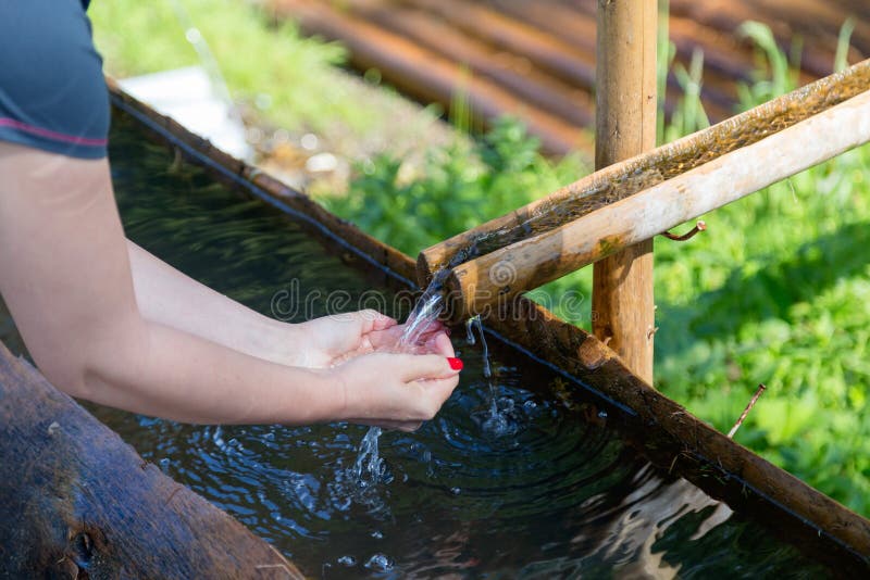Woman Washing Her Hands in a Stream Stock Image - Image of season ...