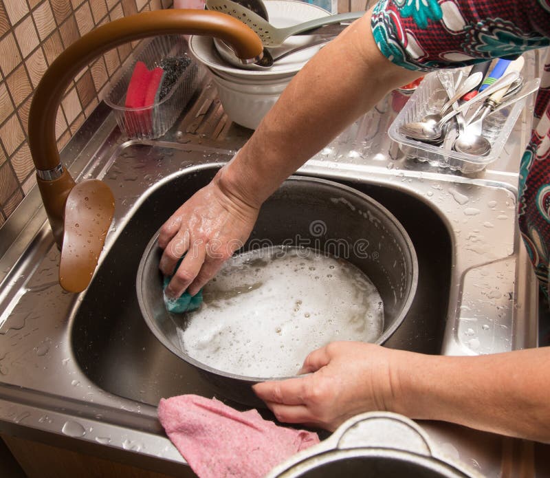 A Woman is Washing a Pan in a Sink Stock Photo - Image of women ...