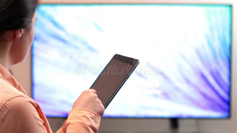 Woman Watches Television while Holding a Tablet Device Stock Video ...
