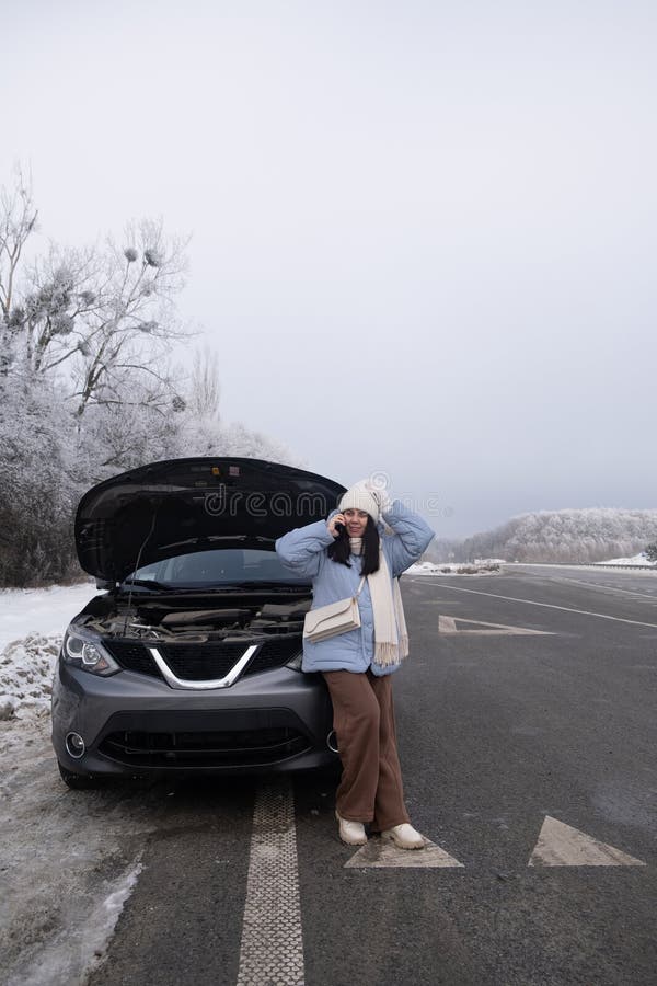 Woman Watching at Car Engine on Snowy Roadside Stock Photo - Image of ...