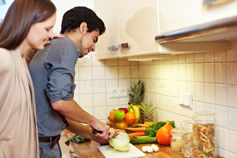 Woman watching man cook stock photo. Image of homemaker - 18670862