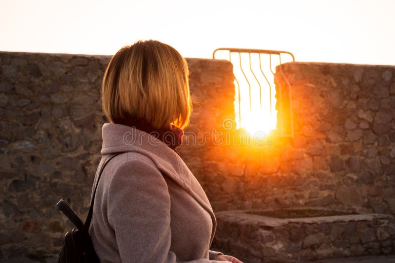 Woman Watching the Sun at Sunset Stock Photo - Image of fence, metal ...