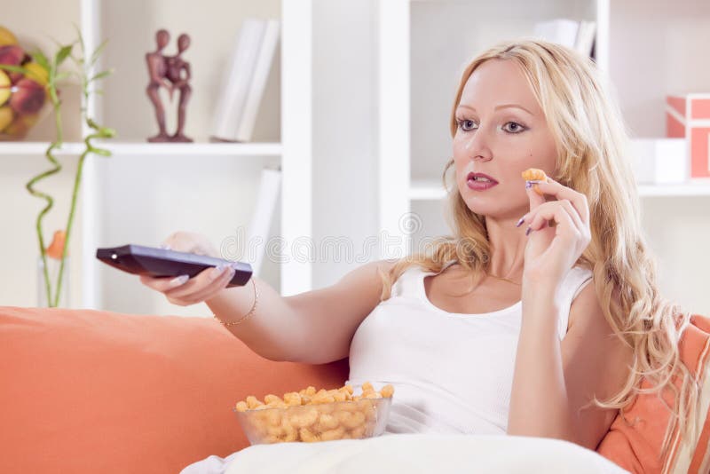 Woman watching television stock photo. Image of snack - 20191744
