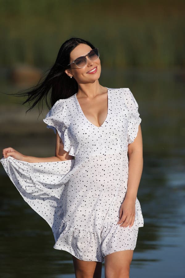 Young Woman in the Water in a Dress Stock Photo - Image of splash, tide ...