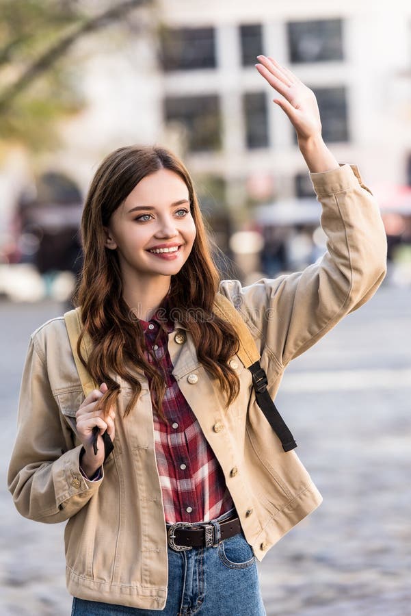 Woman Waving Hand and Smiling with Stock Photo - Image of checkered ...