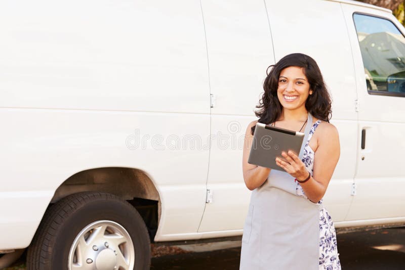 Woman Wearing Apron with Digital Tablet in Front of Van Stock Photo ...