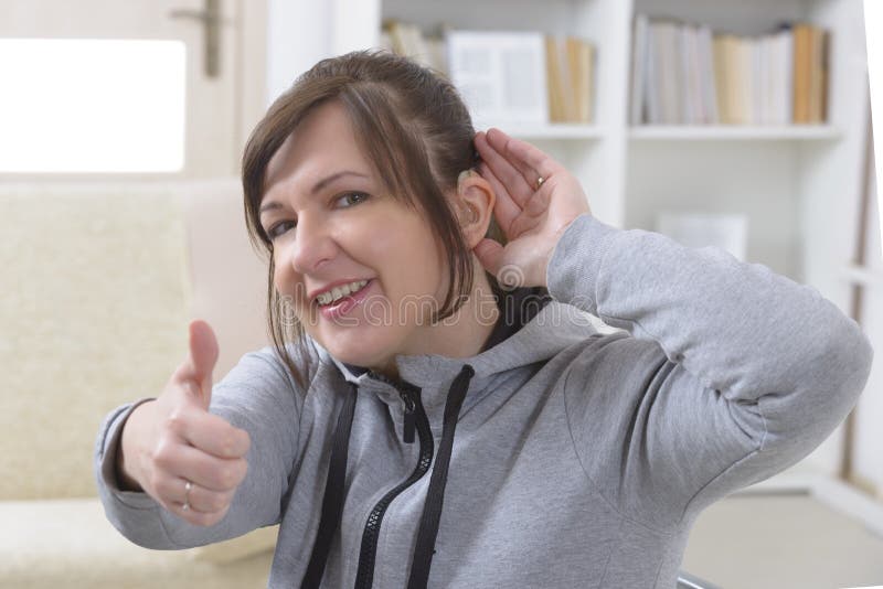 Woman wearing deaf aid stock photo. Image of audiology - 198225632