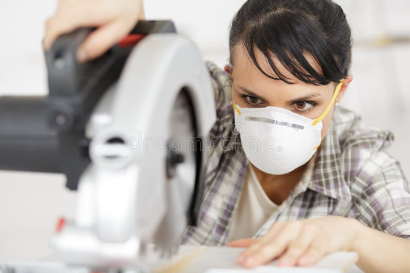 Woman Wearing Face Mask Using Circular Saw Stock Photo - Image of ...