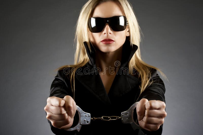 Woman wearing handcuffs stock image. Image of female - 13495519