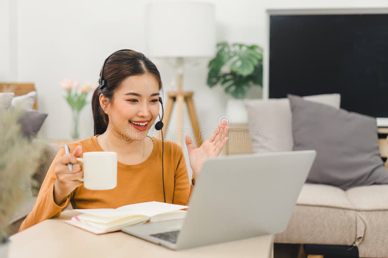 Woman Wearing a Headset, Actively Engaged in an Online Learning Session ...