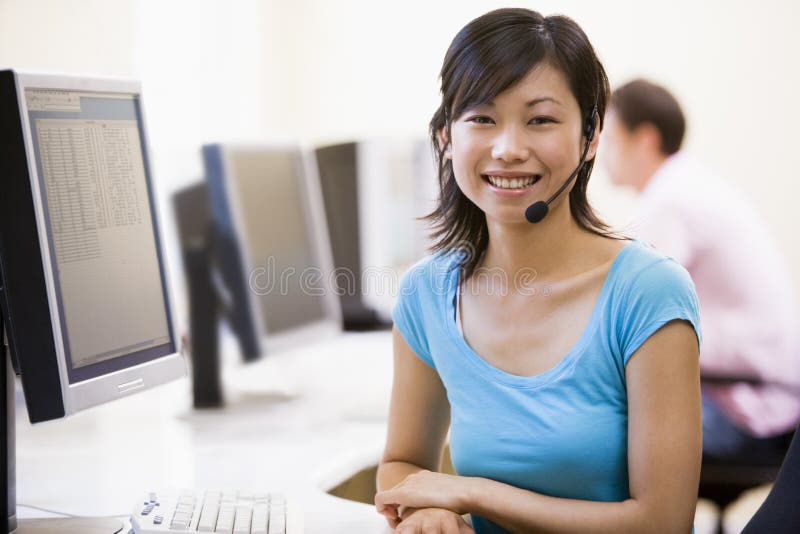 Woman Wearing Headset in Computer Room Smiling Stock Image - Image of ...