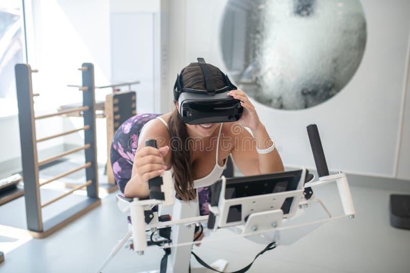 Woman Wearing VR Glasses Doing Exercises in a Gym Stock Image - Image ...