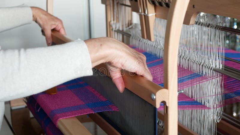 Woman is Weaving Magenta and Blue Fabric. Weaving Process Using Table ...