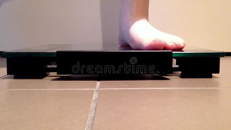 Weight Scales on the Floor. Girl Legs Step on Bathroom Scale Stock ...