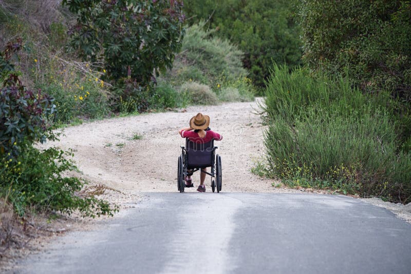 Woman in Wheelchair at End of Pavement Stock Image - Image of outdoors ...
