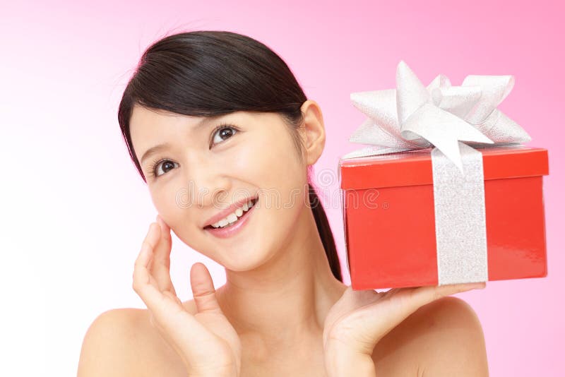 Smiling woman with a gift stock image. Image of comfortable - 131273707