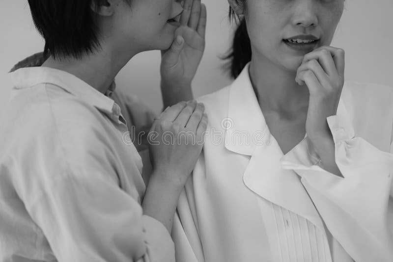 A woman who talks secretly stock photo. Image of face - 232401094