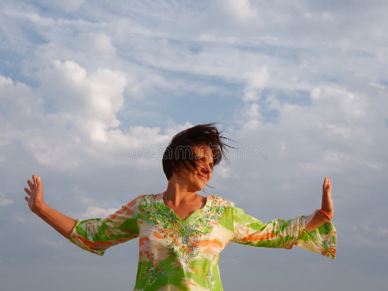 Woman in the Wind Against a Blue Sky with Clouds Stock Photo - Image of ...