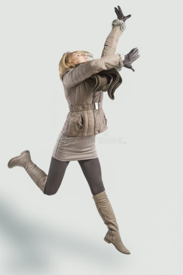 Woman in Winter Clothes Jumping Stock Photo - Image of gloves, body ...