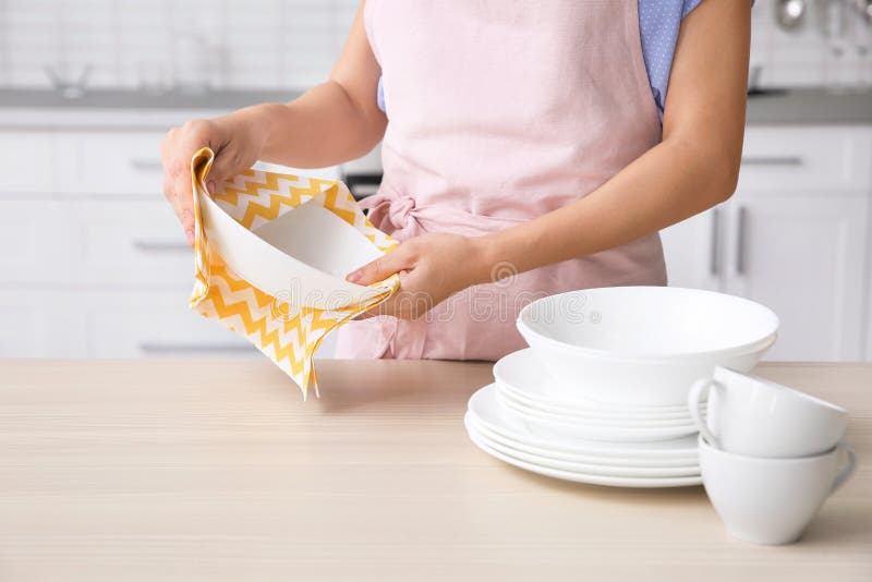 Woman Wiping Clean Dish at Table in Kitchen Stock Photo - Image of ...