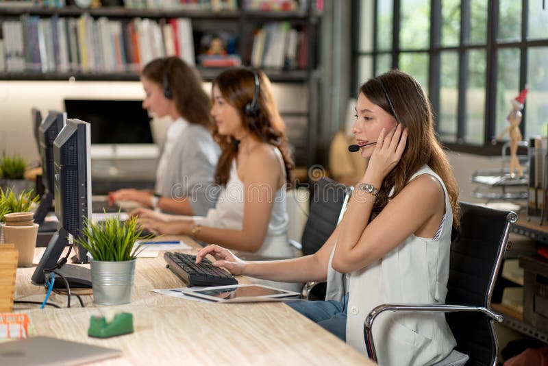 Woman Work with Other Co-workers in Office As Teamwork of Operator or ...