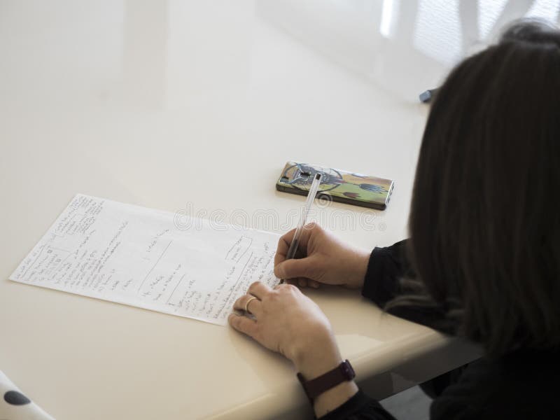 Woman at work taking notes stock image. Image of person - 200878177