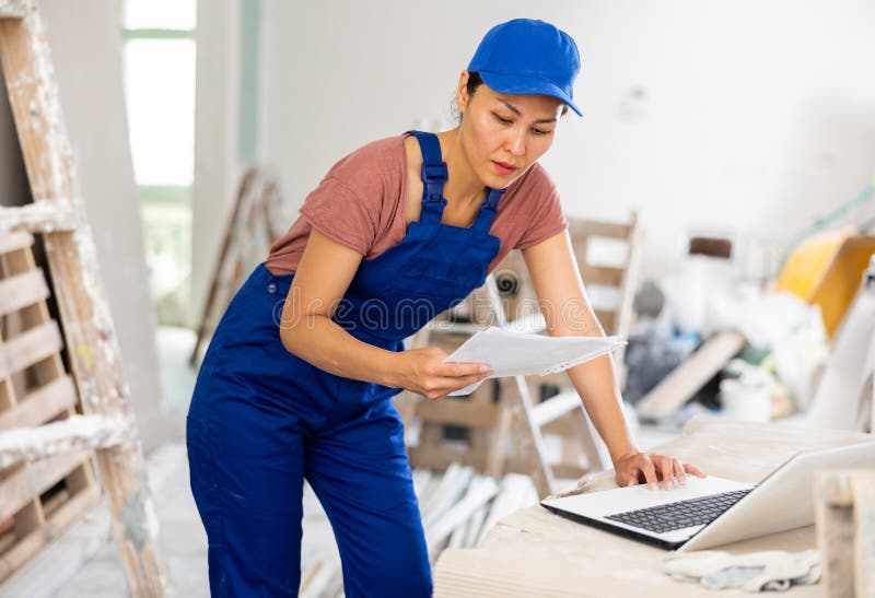 Woman Worker Checking Documents and Using Laptop in Construction Site ...