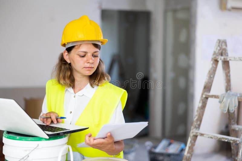 Woman Worker Checking Documents and Using Laptop in Construction Site ...