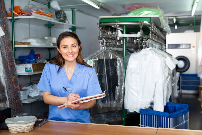 Woman Worker of Laundry Writing Receipt while Taking Clothes for ...