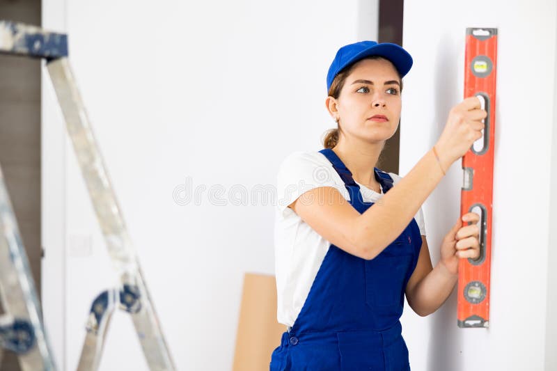 Woman Worker Measuring Wall with Spirit Level Stock Photo - Image of ...