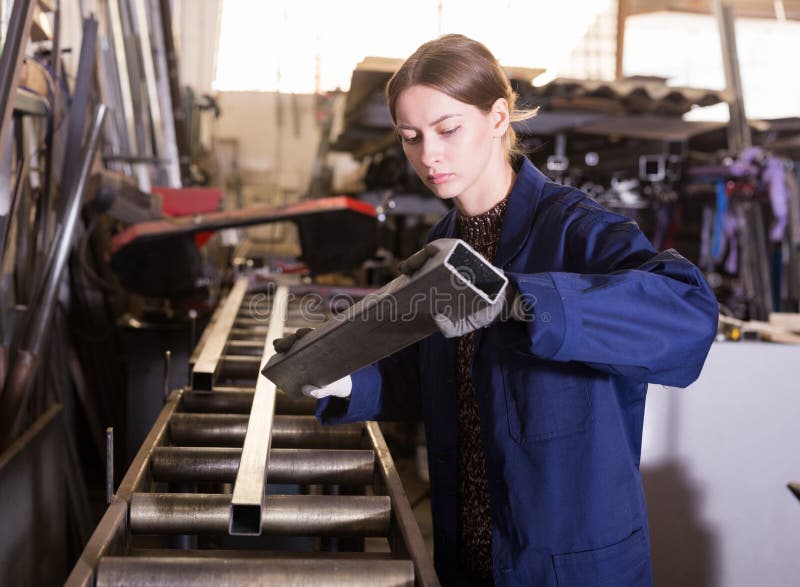 Woman Worker with Metal Beams during Work in Workshop Stock Image ...