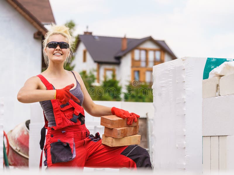 Woman working with bricks stock photo. Image of builder - 132582744