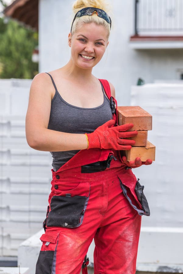 Woman working with bricks stock photo. Image of clay - 312068810