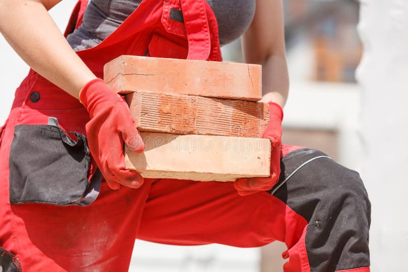 Woman working with bricks stock image. Image of brick - 242467729