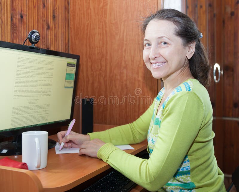 Woman working at computer stock image. Image of table - 58838235