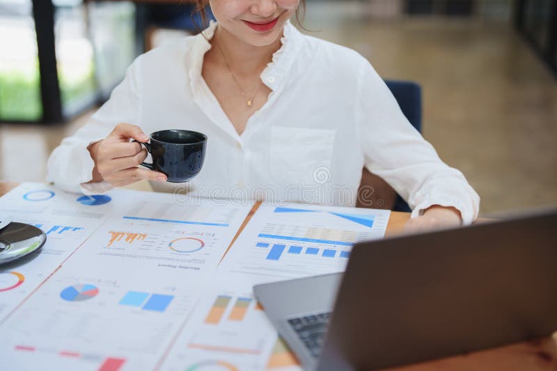Woman Working on a Computer, Budgeting Documents and Drinking Coffee ...